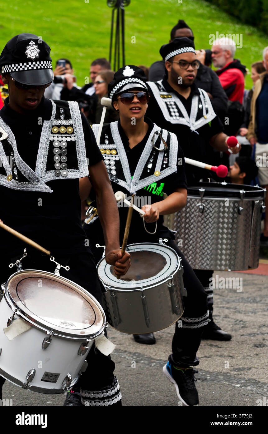 Drum and dance troupe dressed as American police taking part in the ...