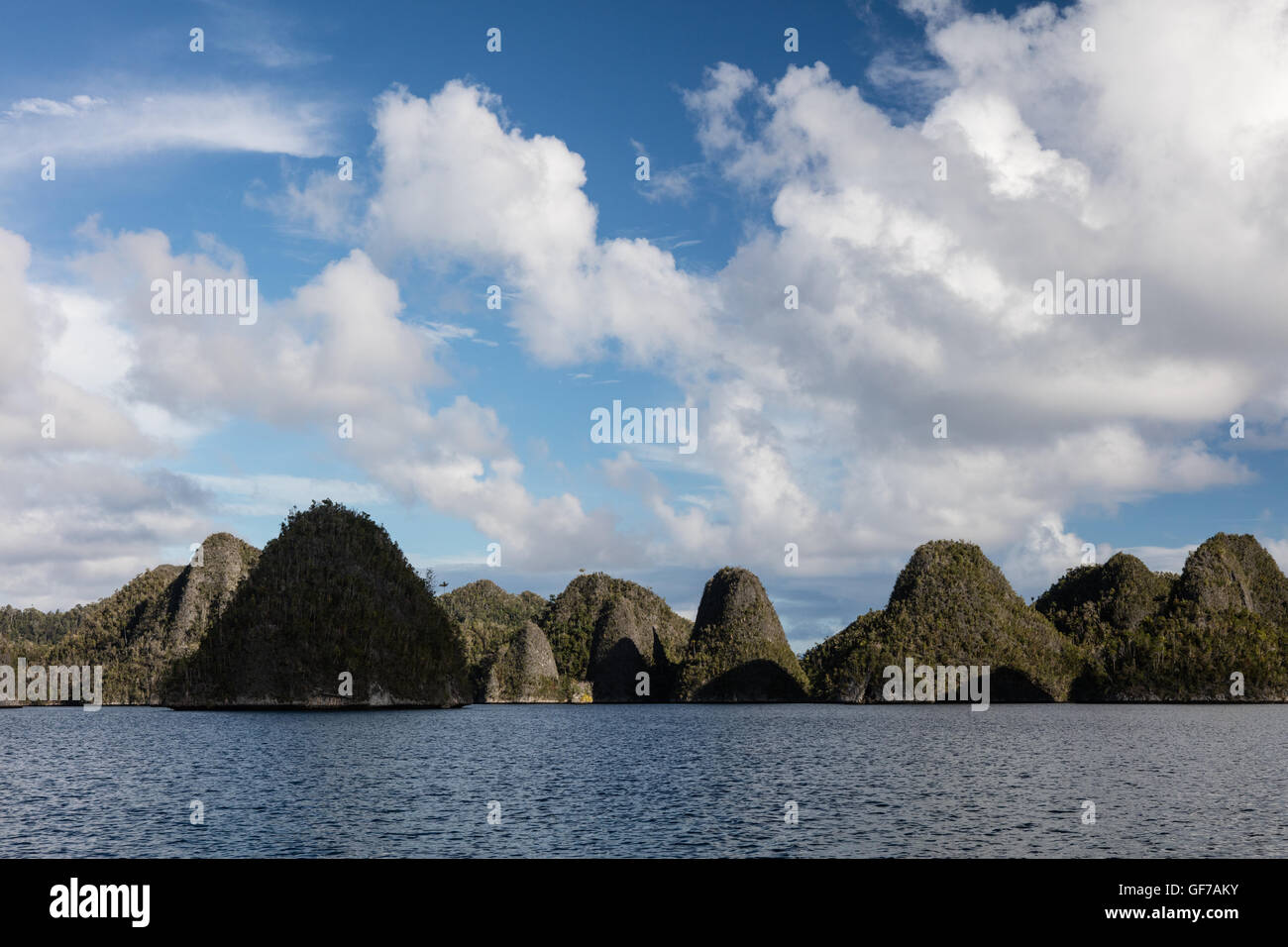 Rugged limestone islands surround a remote, tropical lagoon in Wayag ...