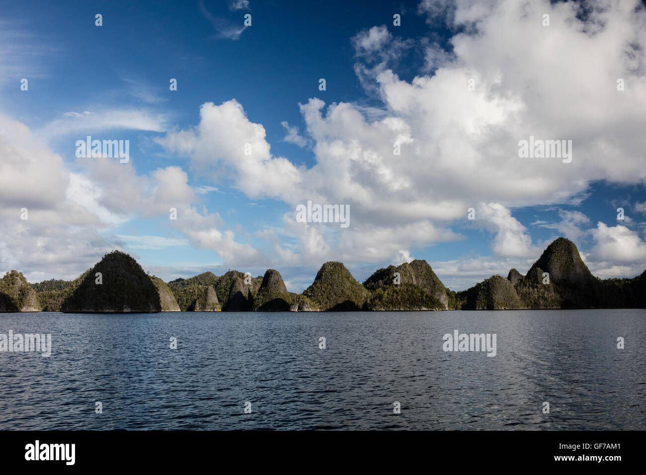Rugged limestone islands surround a remote, tropical lagoon in Wayag ...