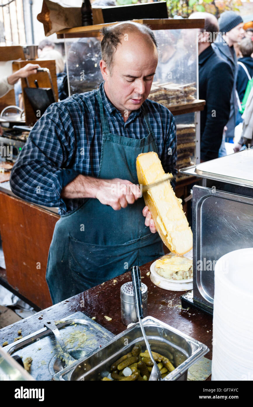 Borough Market, London. A server making raclette Stock Photo - Alamy