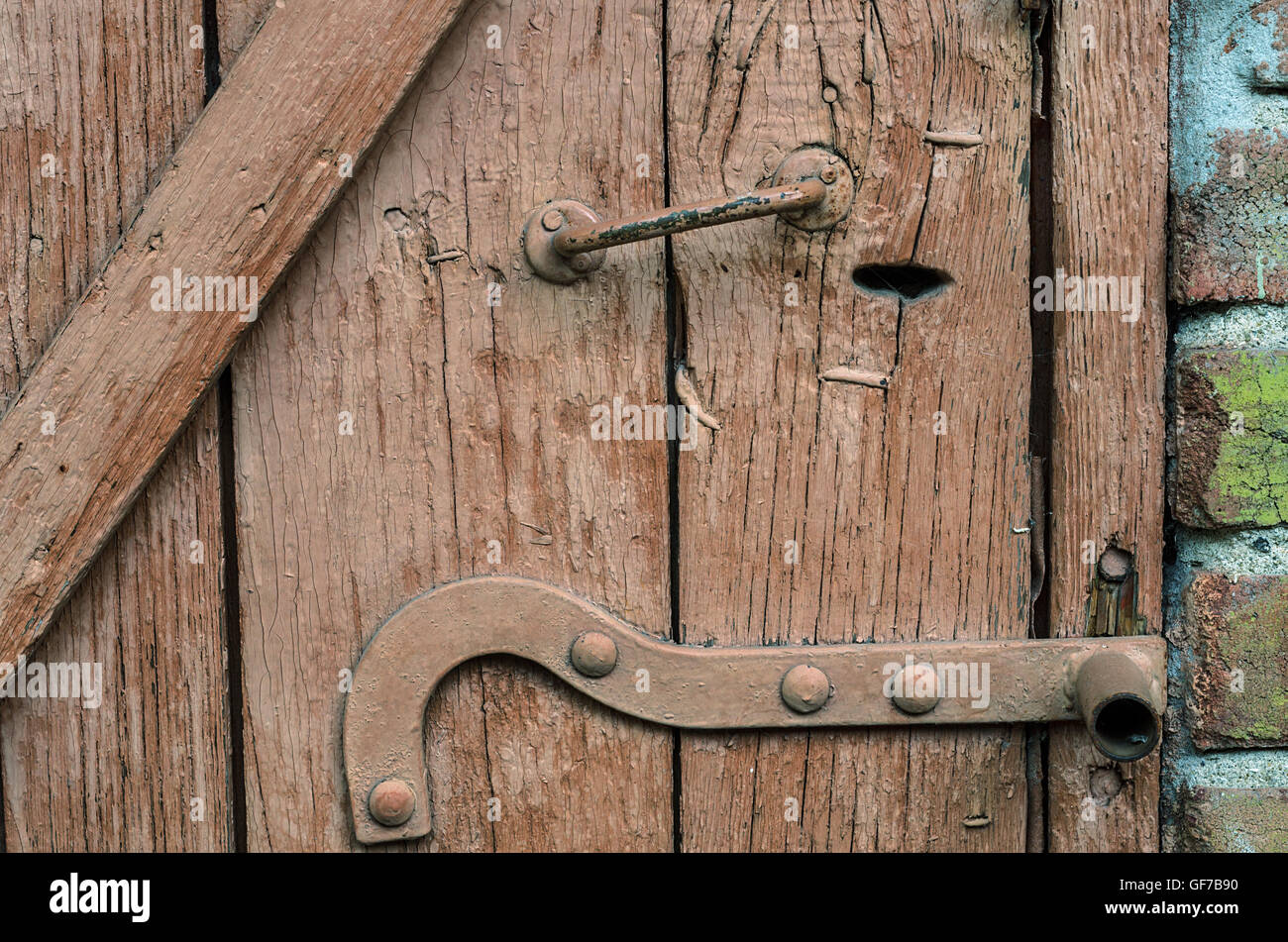 A texture of age wood door with a handle and locking mechanism Stock ...