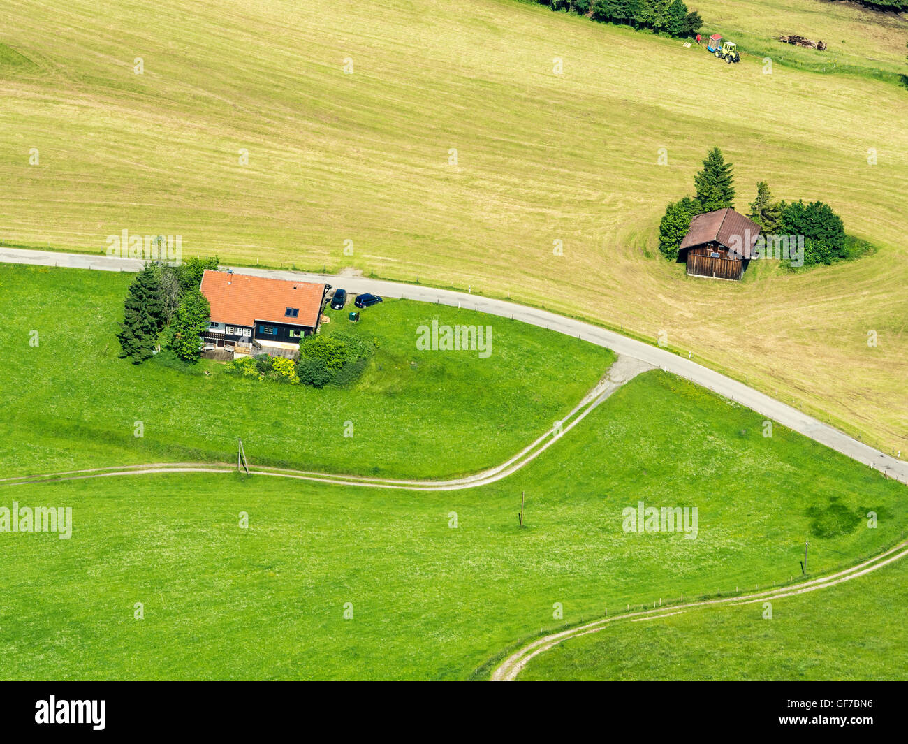 Traditional farm house, small farm road, aerial view, slope of bavarian ...