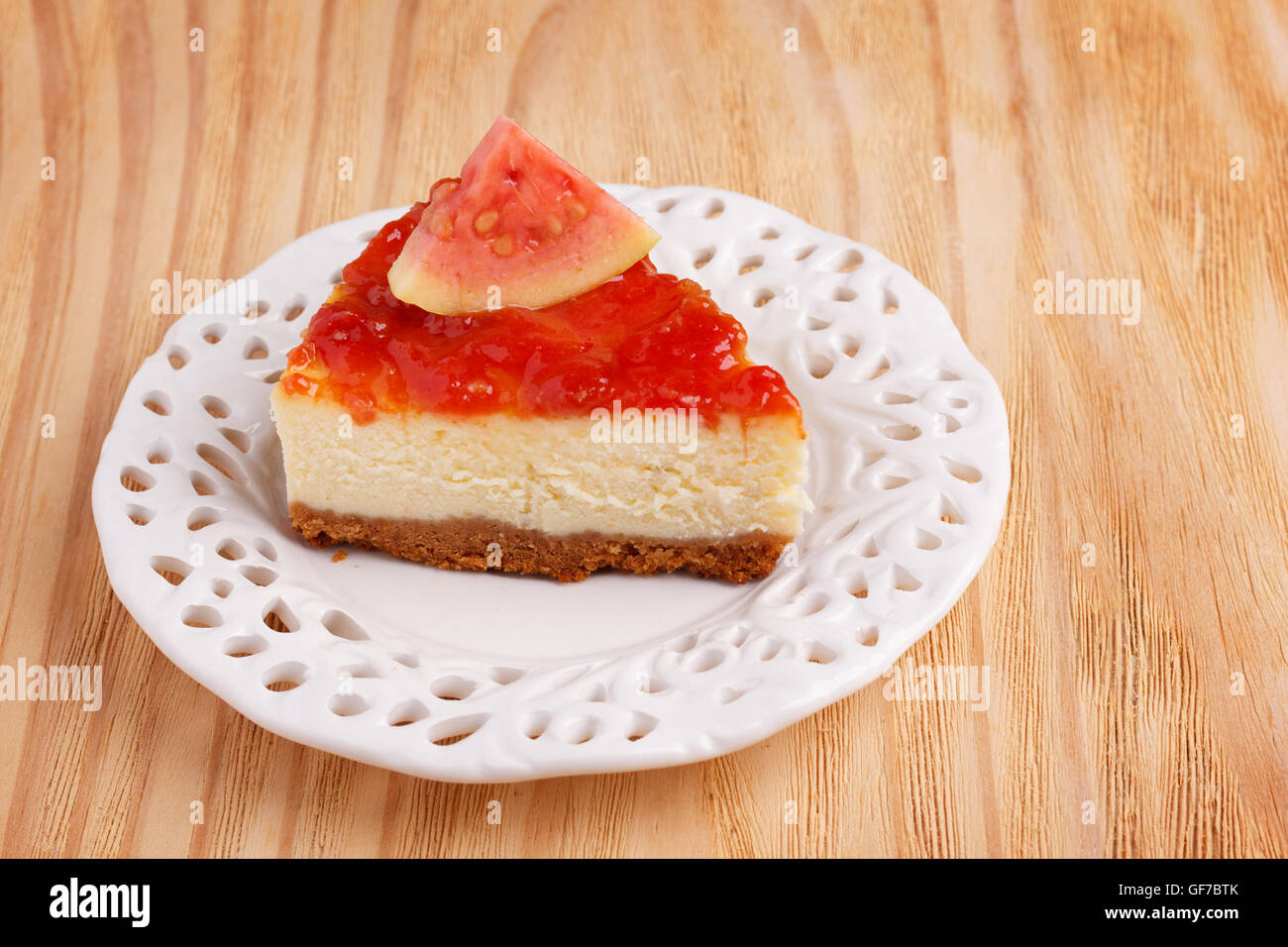 Cheesecake with brazilian goiabada jam of guava on white vintage plate ...