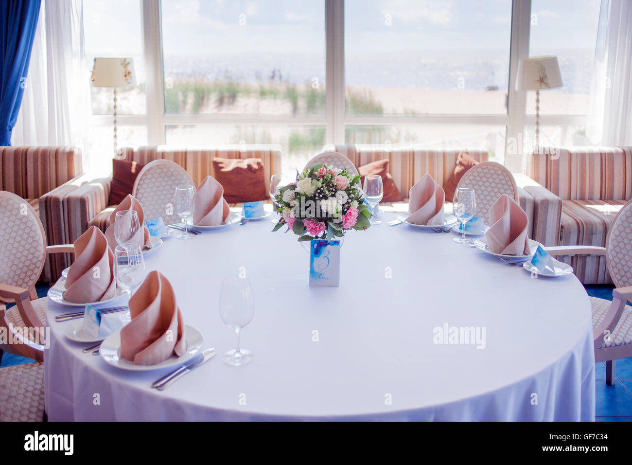 Wedding banquet, small restaurant in a Maritime style, round tables ...