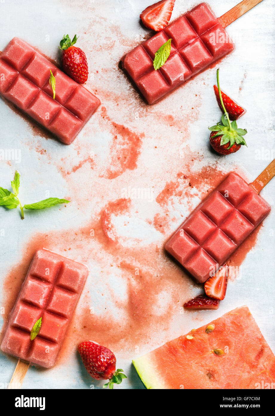 Strawberry watermelon ice cream popsicles with fresh mint leaves over ...