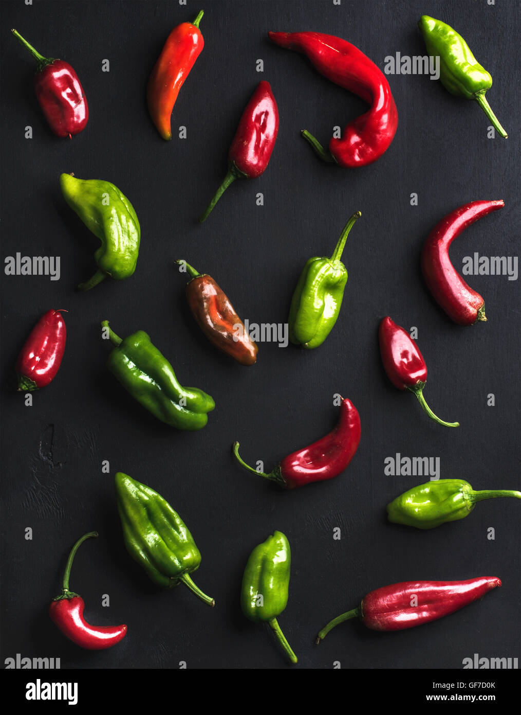 Pattern of small colorful hot chili peppers on black background Stock ...