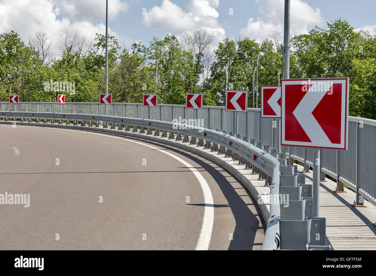 white arrows on red road signs, indicating a protracted left turn Stock ...