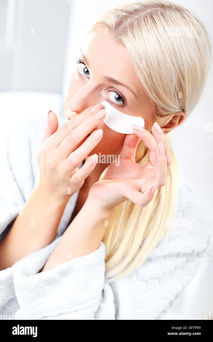 The woman applied primer on the face using a special sponge makeup ...