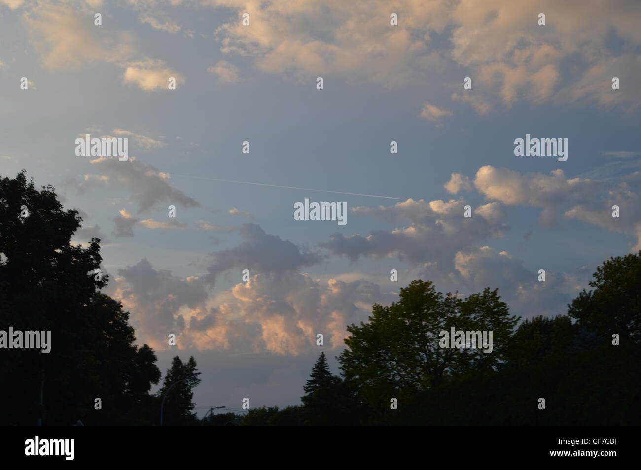 Plane trail in sunset sky hi-res stock photography and images - Alamy