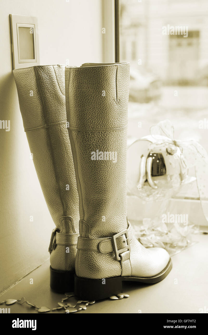 Women's leather boots against the window Stock Photo - Alamy