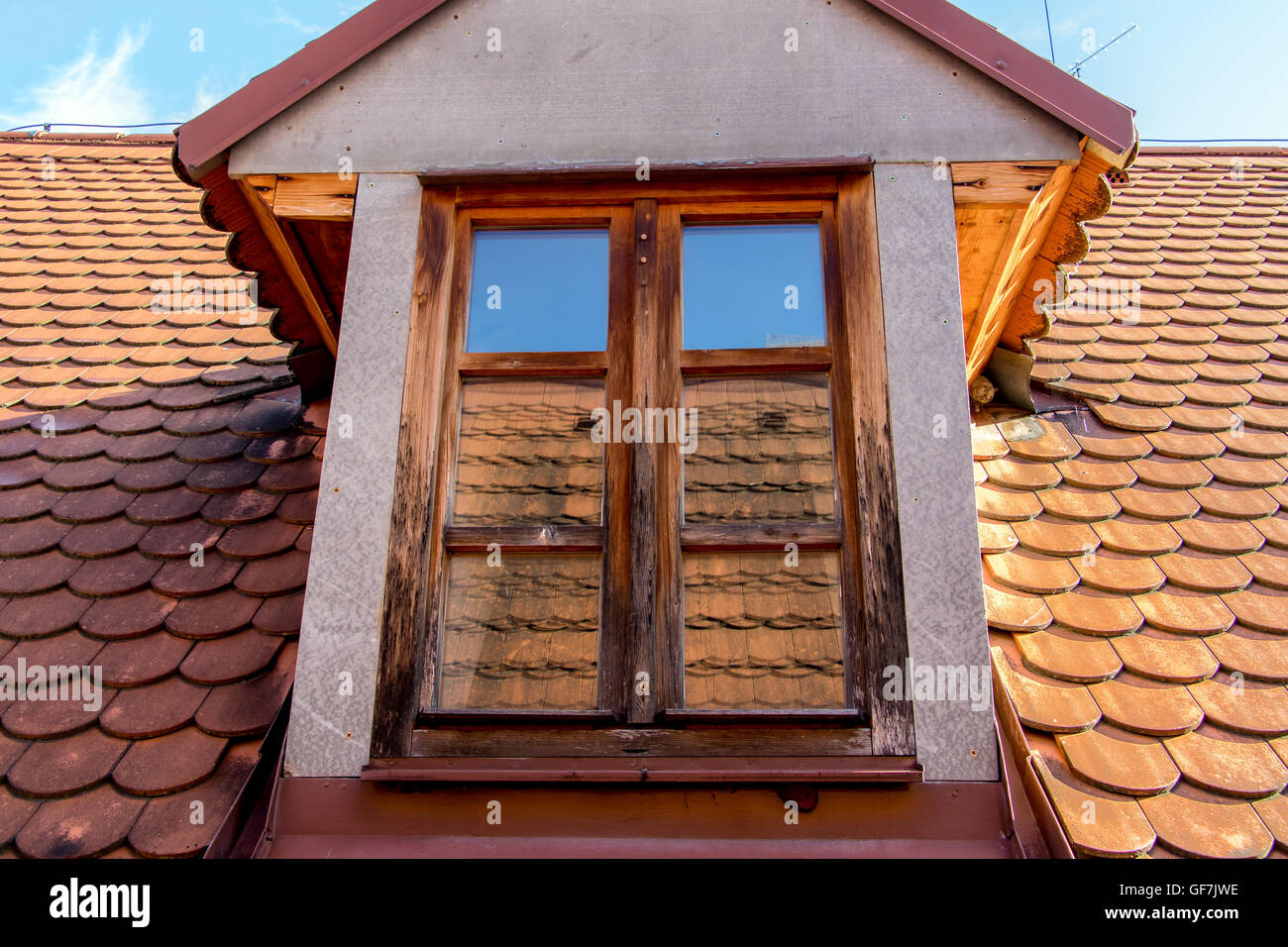 Historical House Roof and Attic Windows with reflection of red roof ...