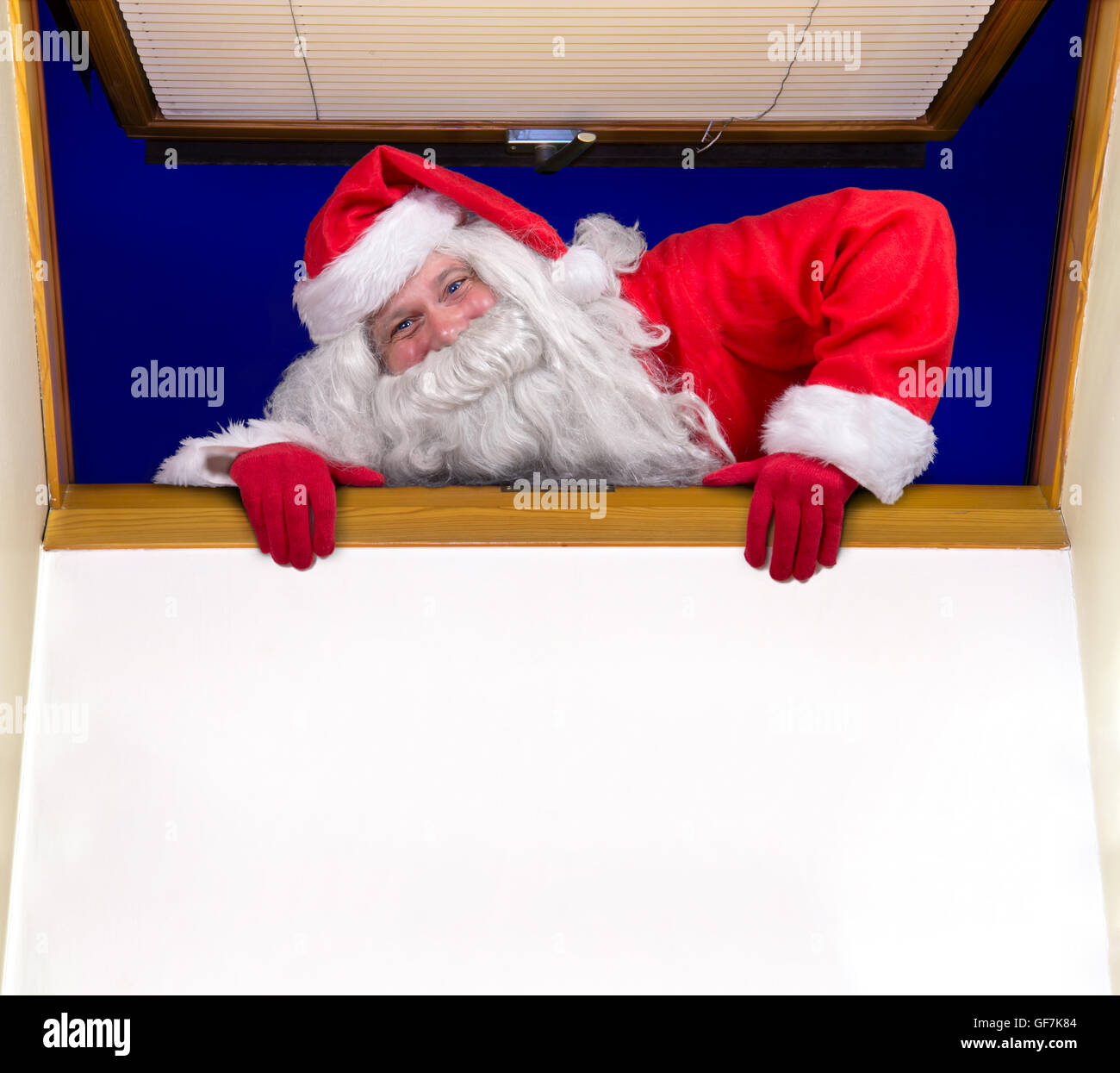 Santa Claus climbs into the room through an open window Stock Photo - Alamy