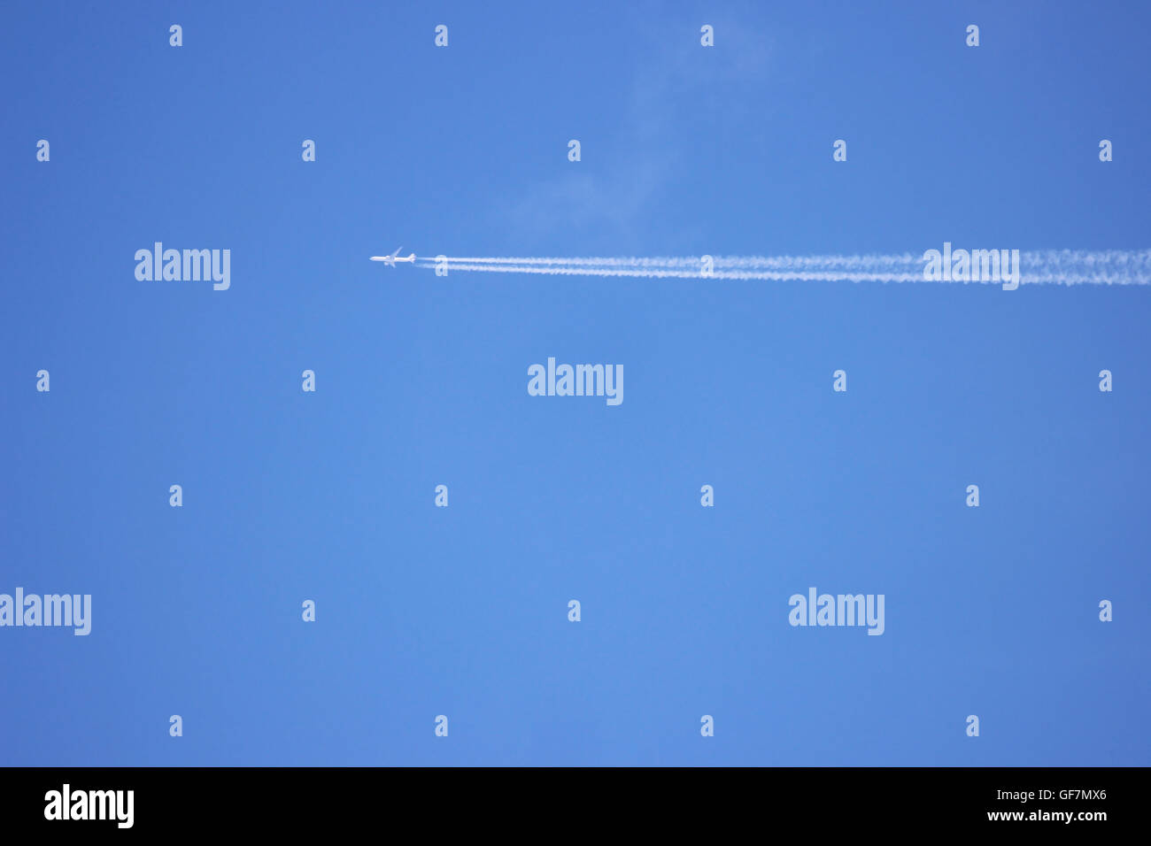 jet aircraft with a white track flying in the blue sky Stock Photo - Alamy