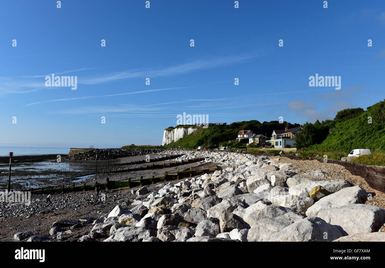The shingle beach slopes down to the English channel, where the clear ...