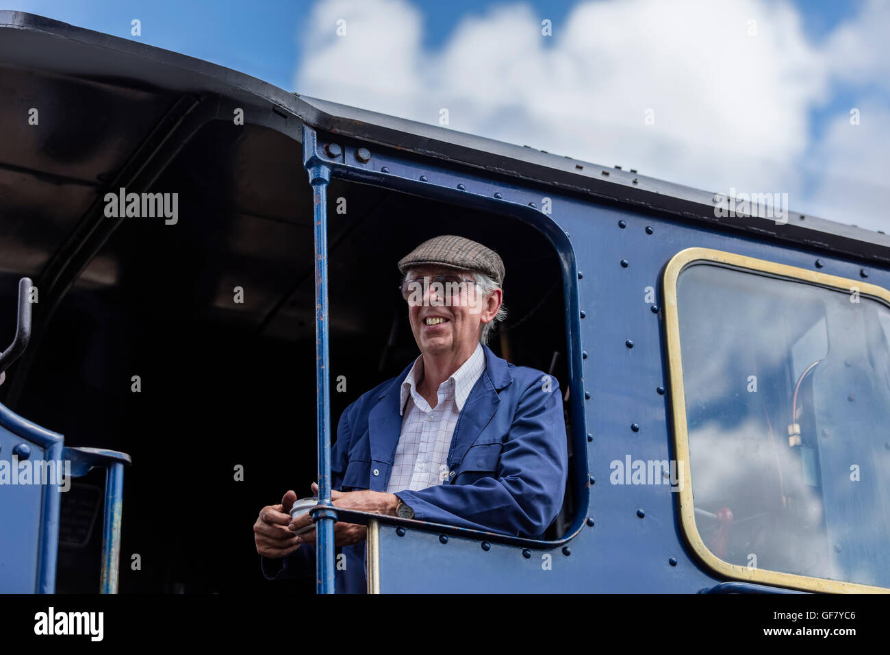Volunteer steam train crew member in the cab of the restored King ...