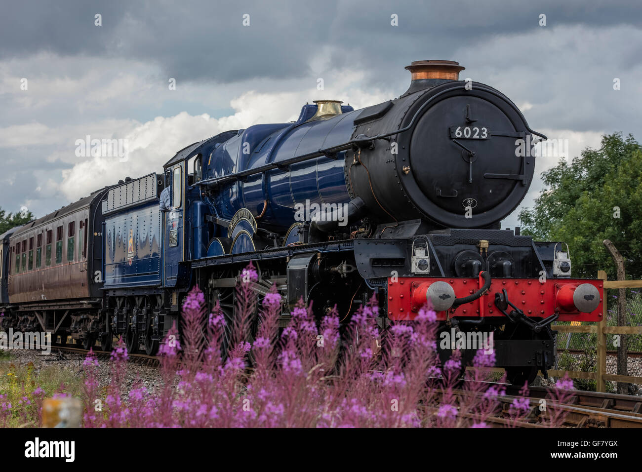 Restored King Edward II steam engine on the track with out of focus ...