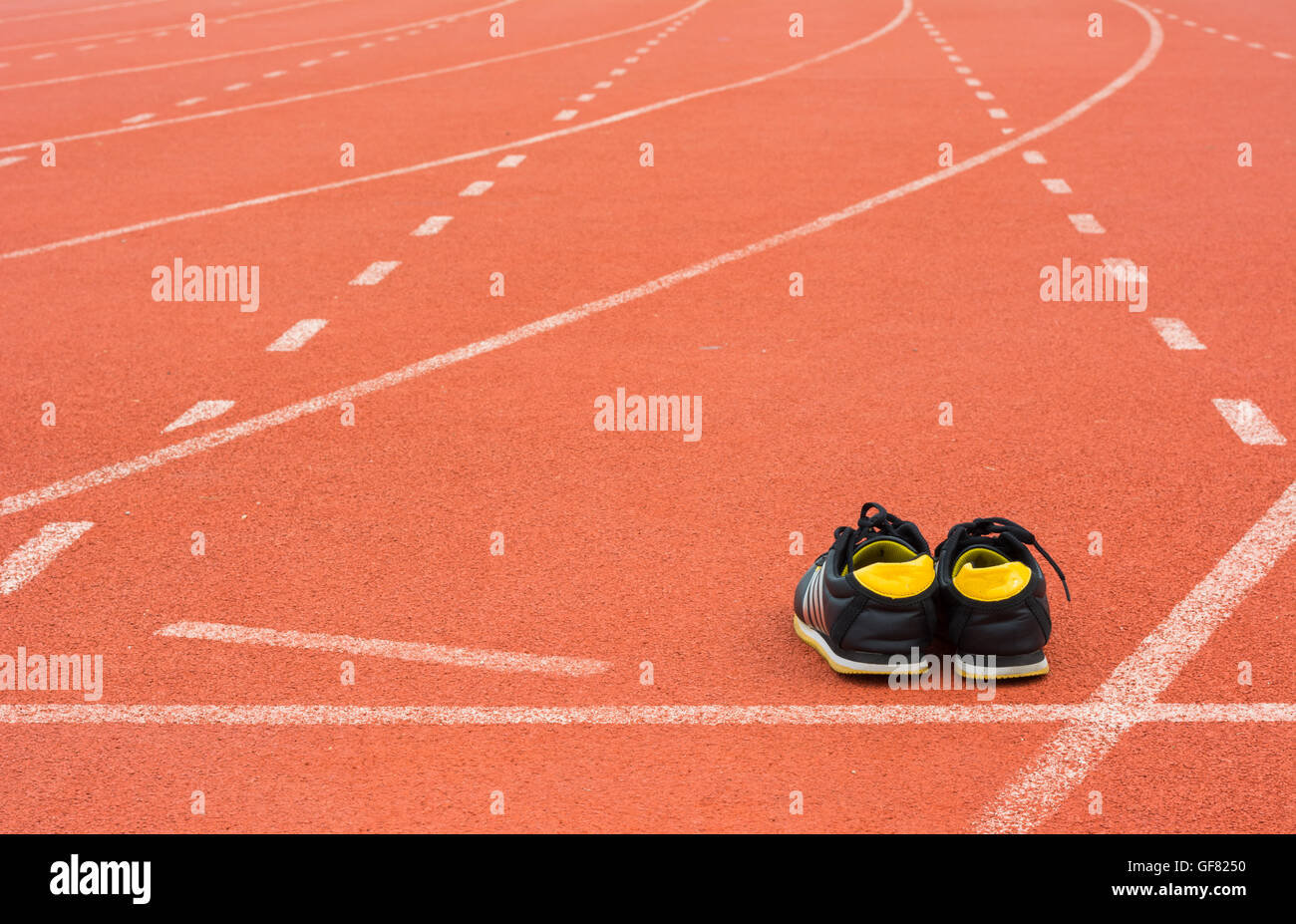 Sport shoes on running track background Stock Photo - Alamy