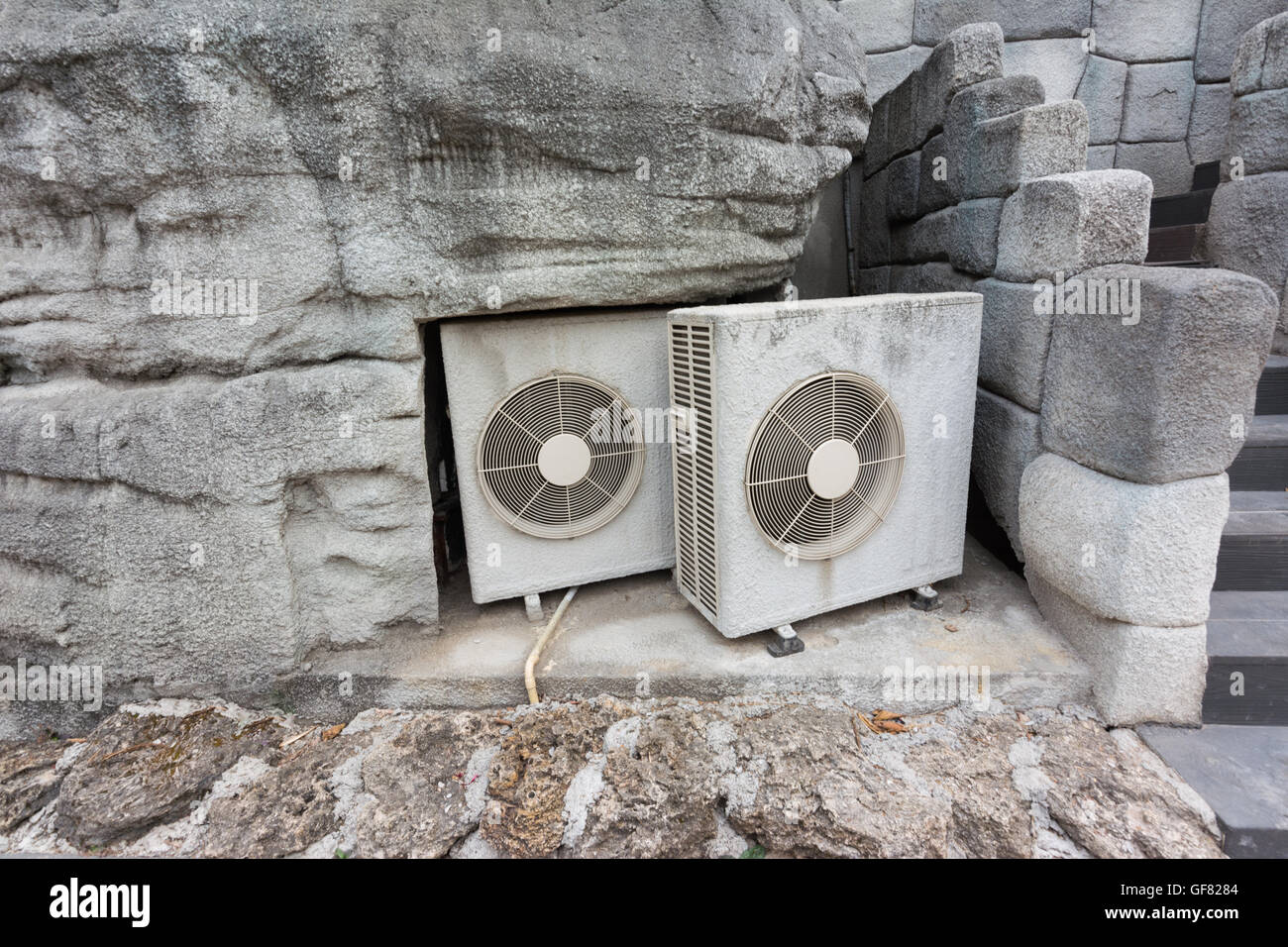Group of air compressor in the stone wall Stock Photo - Alamy