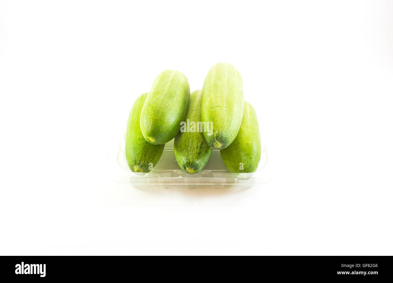 Five green cucumbers stack in plastic tray on white background Stock ...