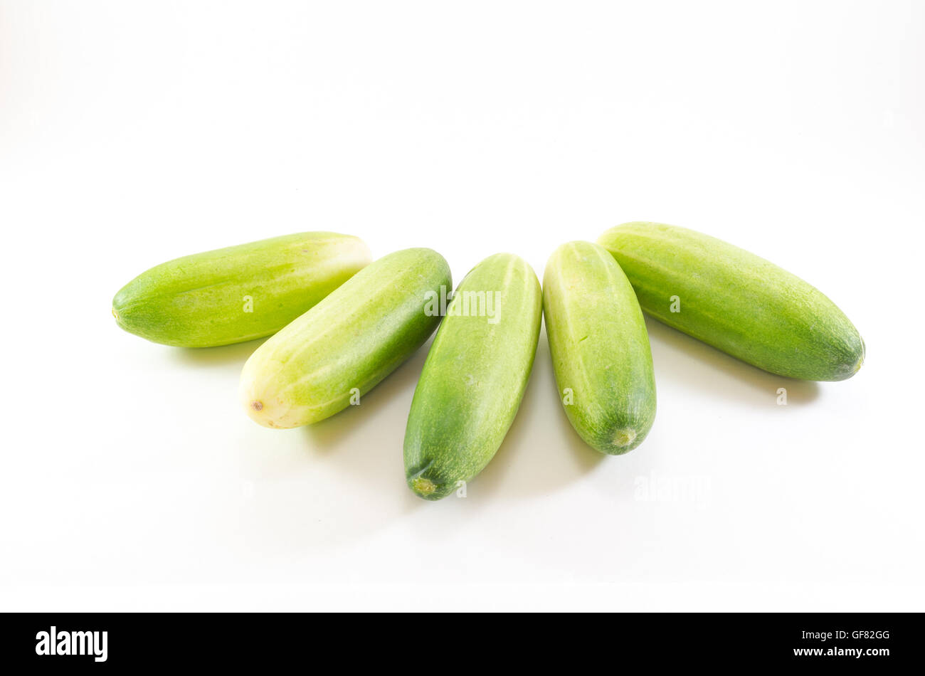 Five green cucumbers in on white background Stock Photo - Alamy