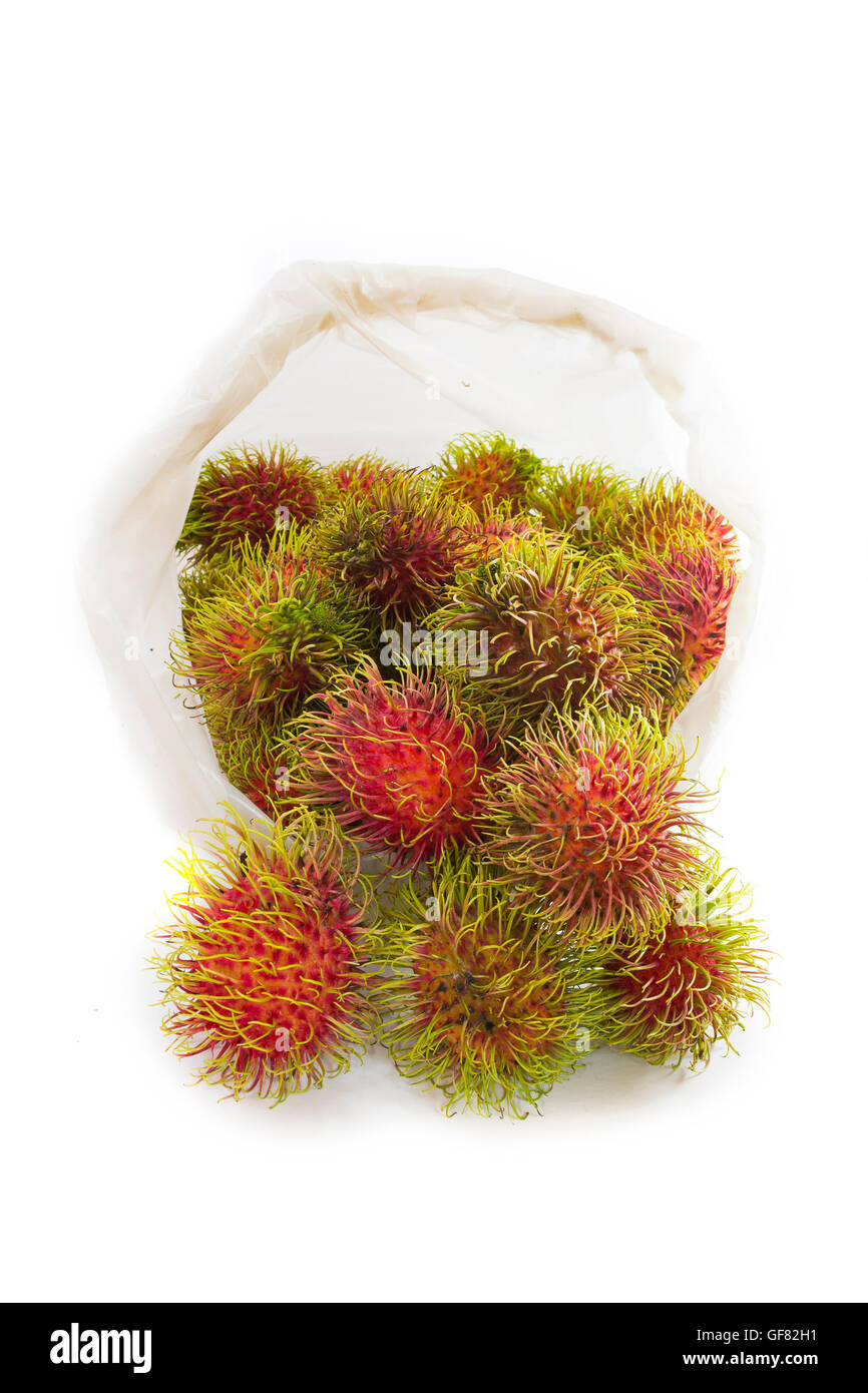 Rambutan Fruit with plastic bag on white background Stock Photo - Alamy