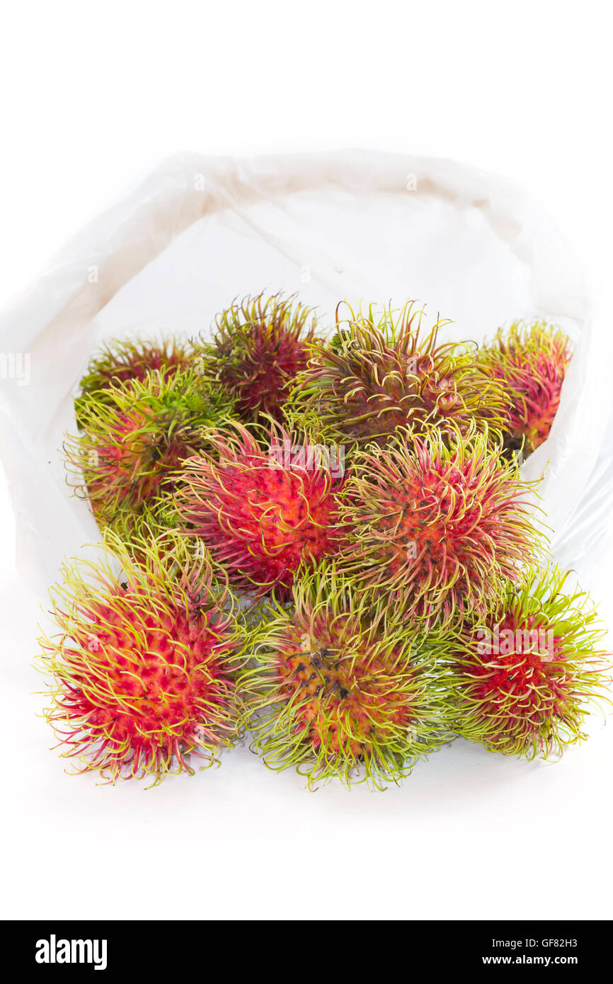 Rambutan Fruit with plastic bag on white background Stock Photo - Alamy