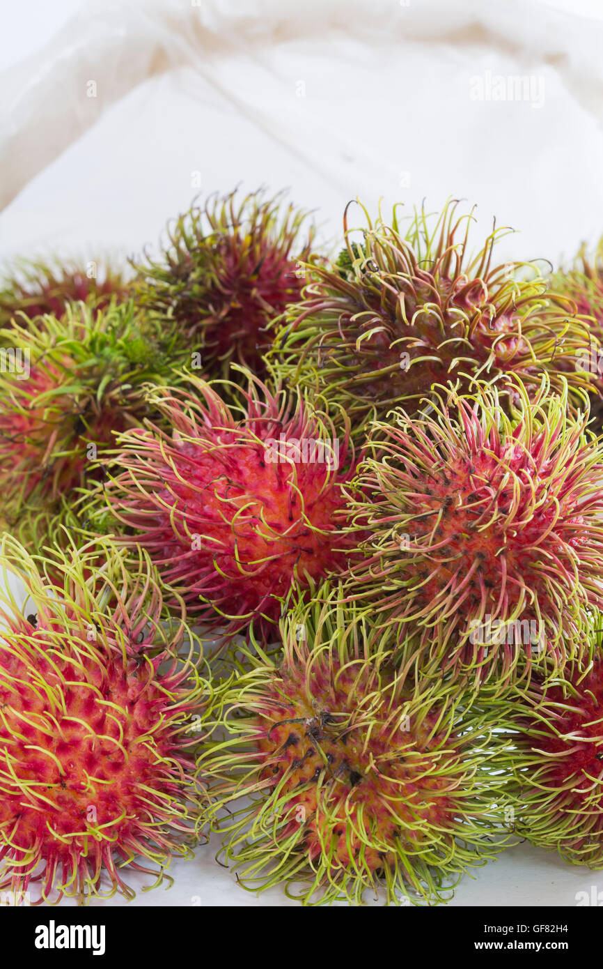 Rambutan Fruit with plastic bag on white background Stock Photo - Alamy