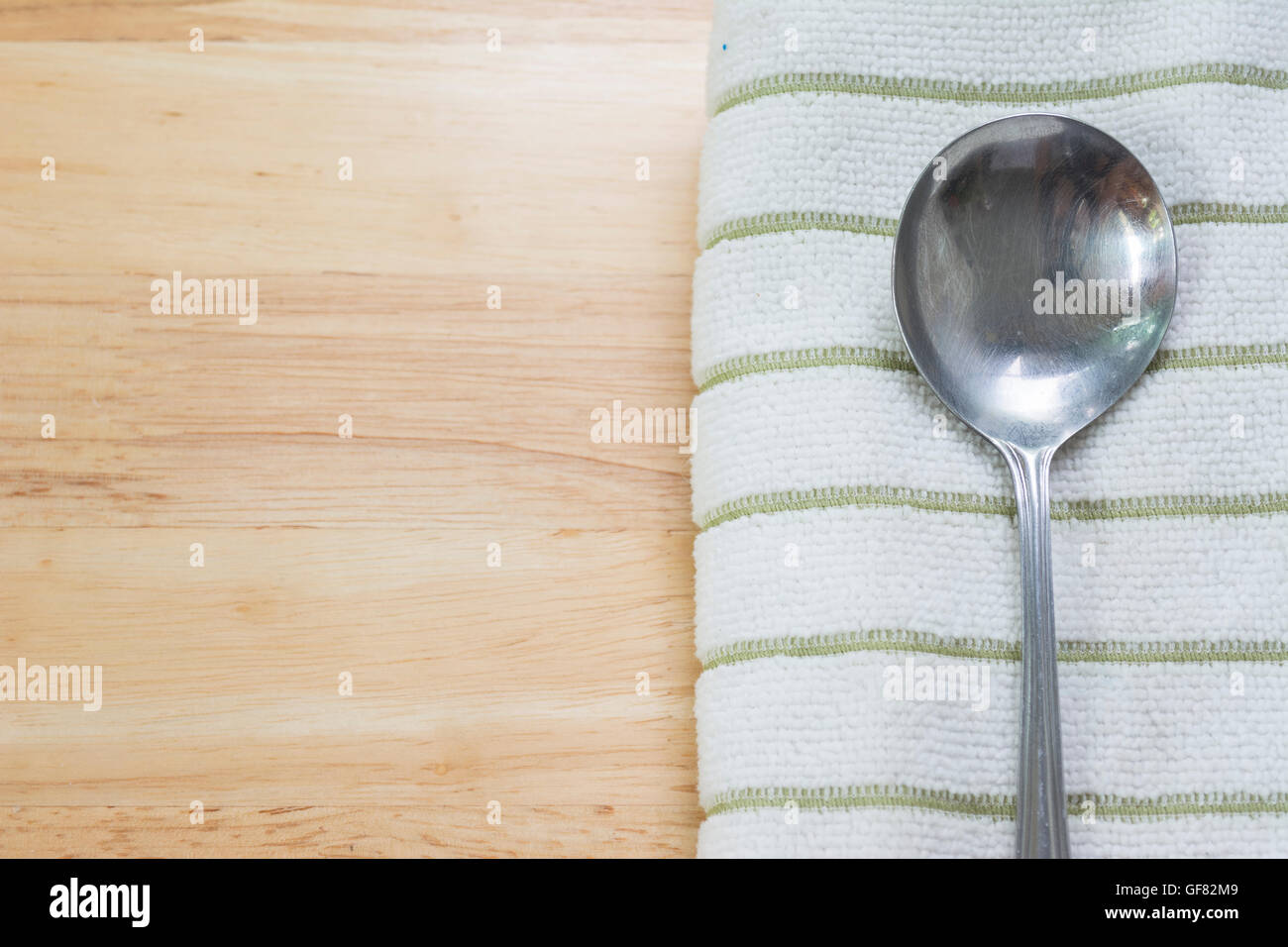 Napkin and spoon on the wood table Stock Photo - Alamy