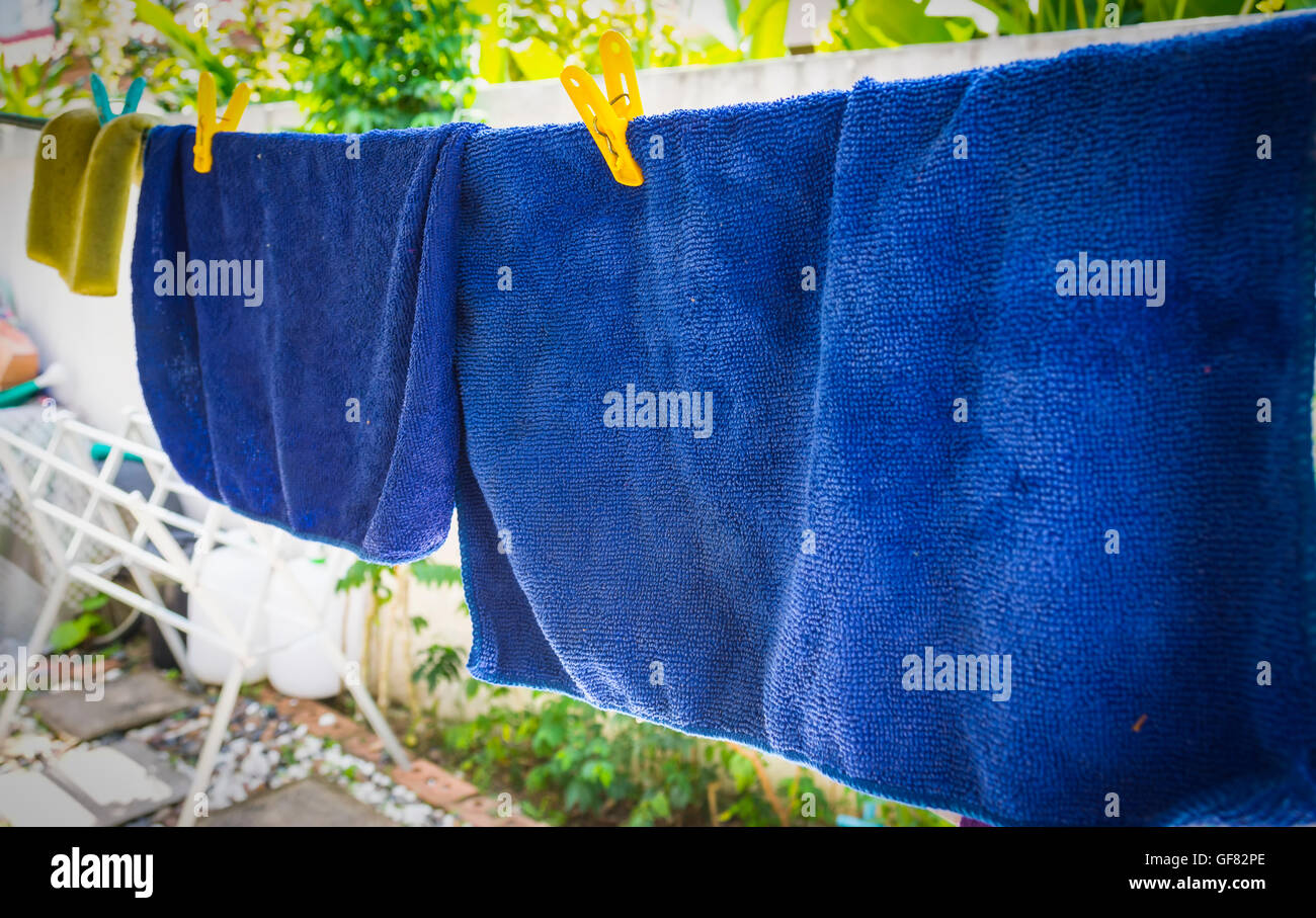 Blue clothing drying Stock Photo - Alamy