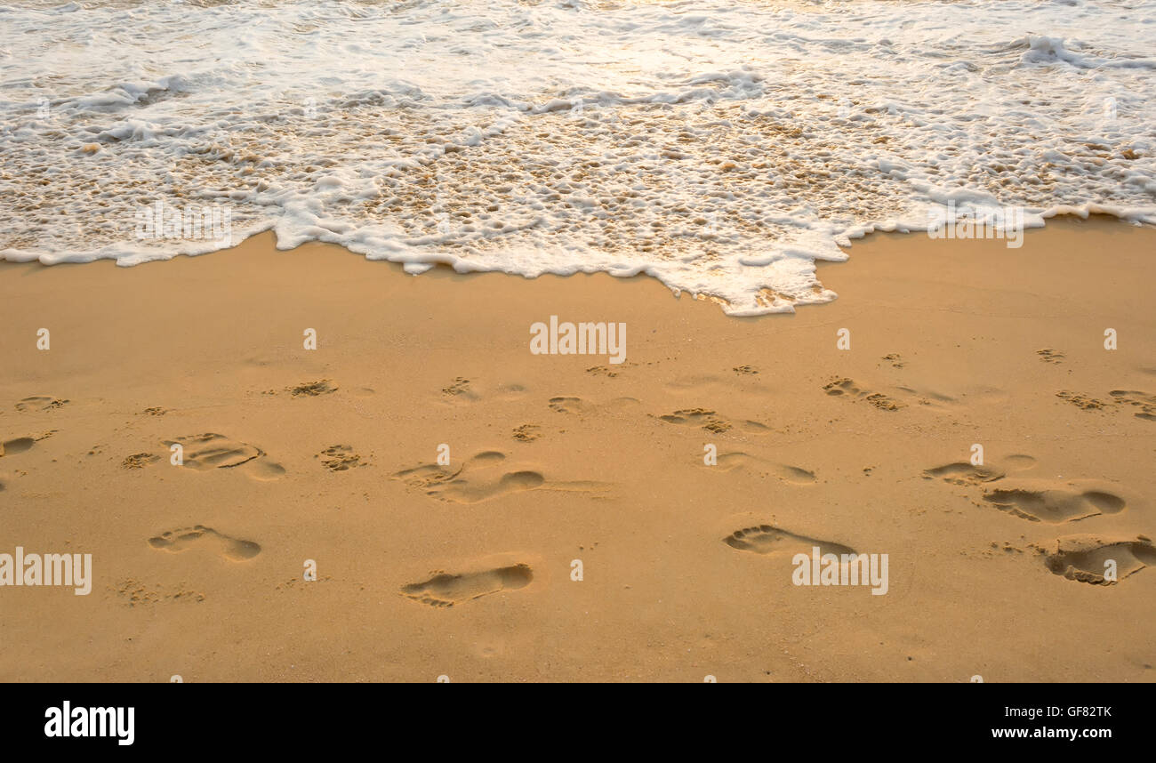 Sea wave and many foot print on the beach background Stock Photo - Alamy