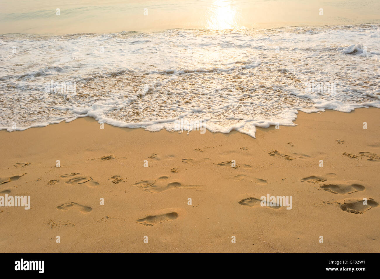 Sea wave and many foot print on the beach background Stock Photo - Alamy