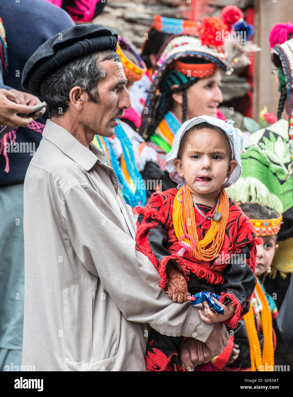 Kalash man holding his daughter at the Joshi festival of Spring Stock ...