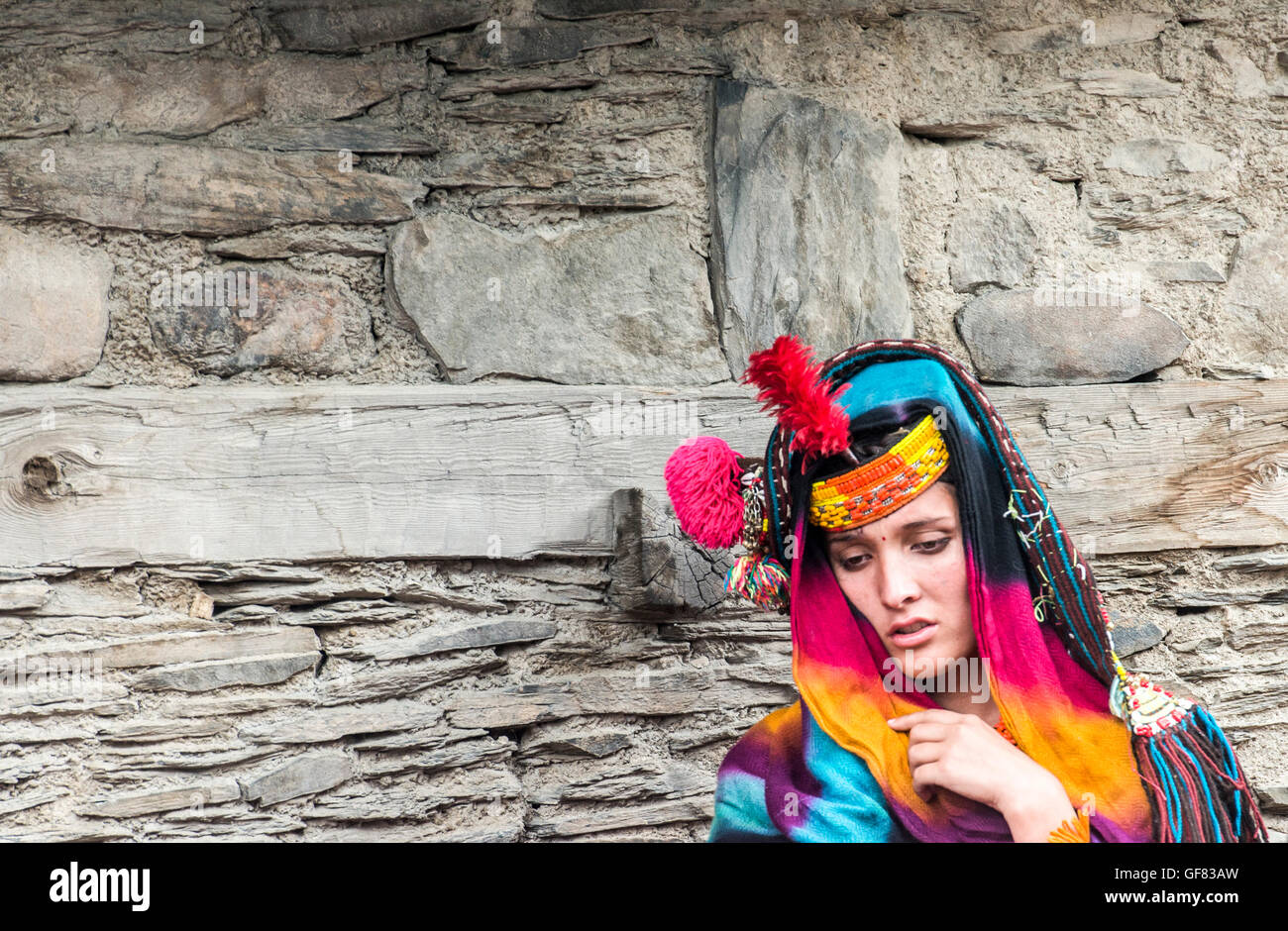 Kalash woman wearing traditional headdress, bead necklaces and ...