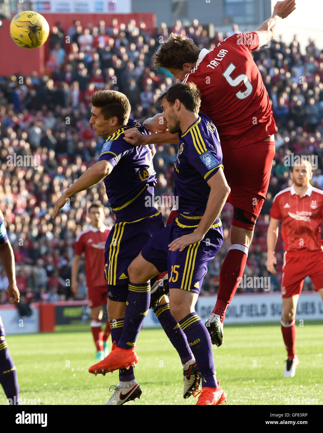 Aberdeen's Ash Taylor heads for goal with Maribor's Blaz Vrhovec and ...