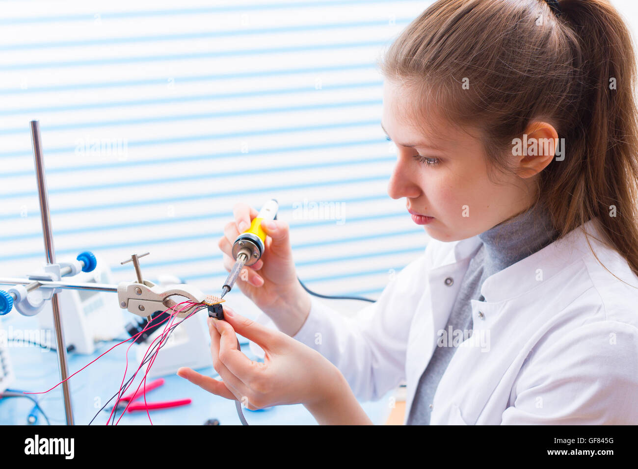 Tech tests electronic equipment in service centre Stock Photo - Alamy