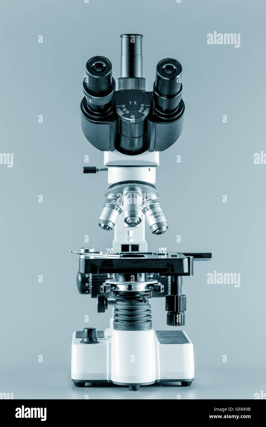 Trinocular microscope on blue background Stock Photo - Alamy