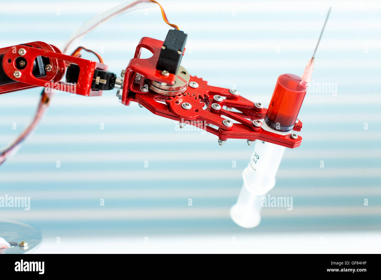 Robot holding a medical syringe Stock Photo - Alamy