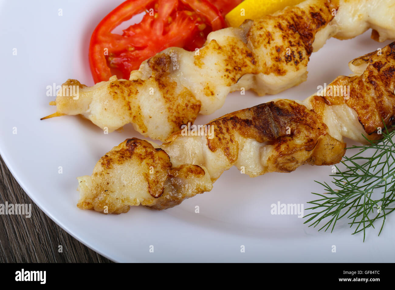 Fish skewer with dill, tomato and lemon Stock Photo - Alamy