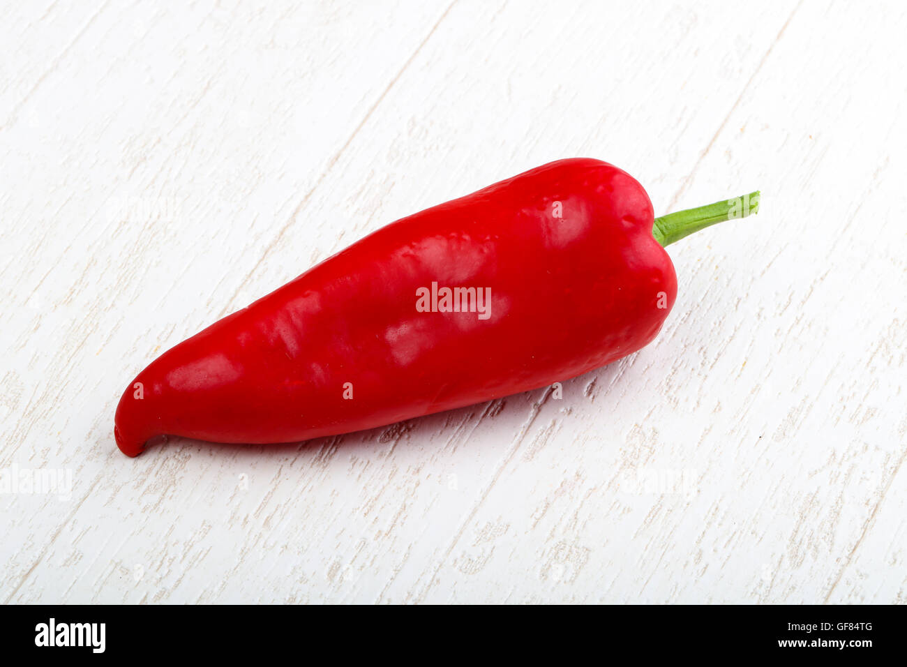 Red romano pepper on the wood background Stock Photo - Alamy
