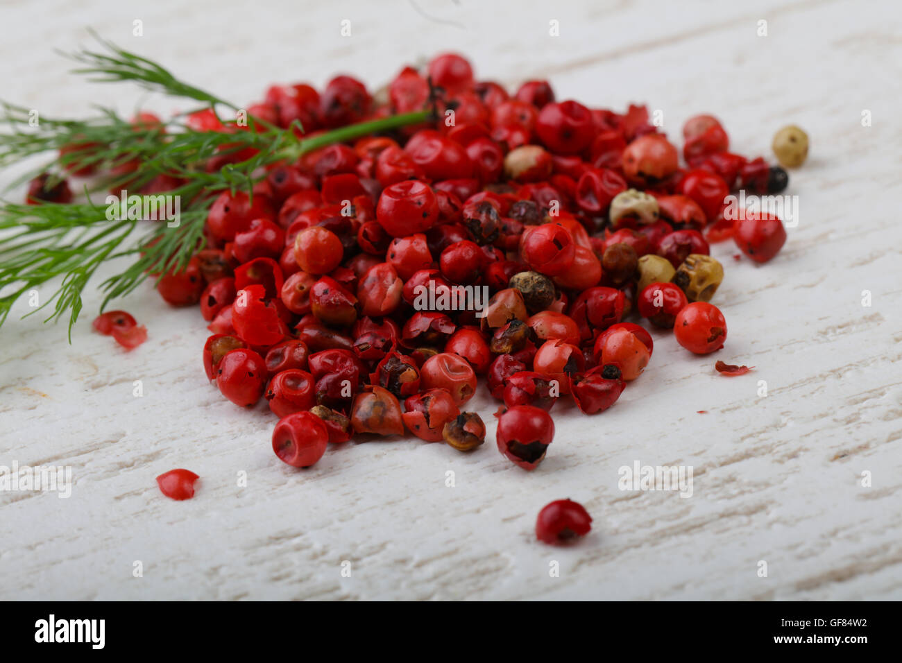 Red pepper corn on the wood background Stock Photo - Alamy