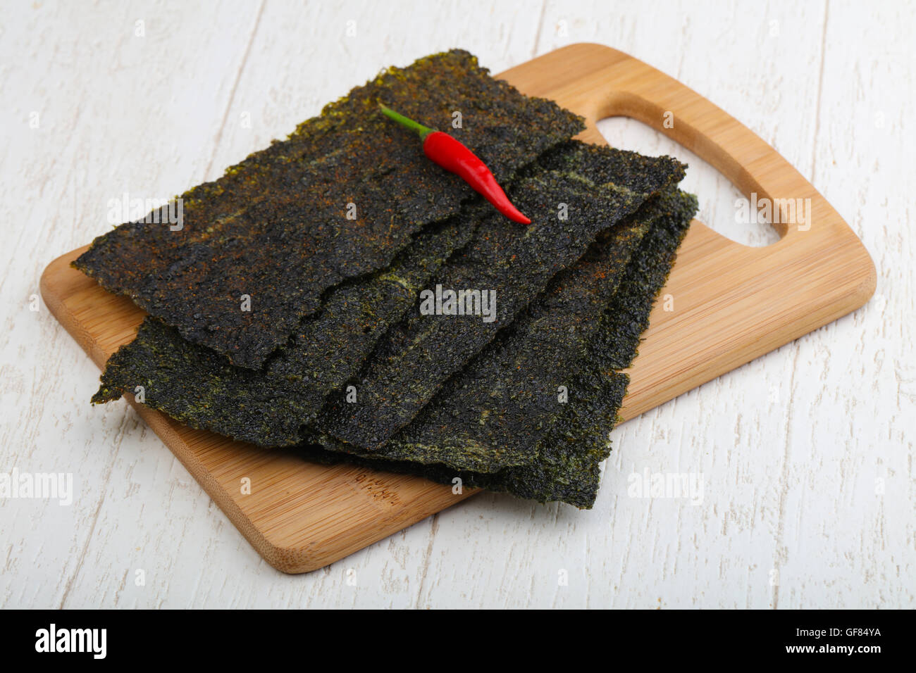 Spicy Nori seaweed sheets with pepper on wood Stock Photo - Alamy
