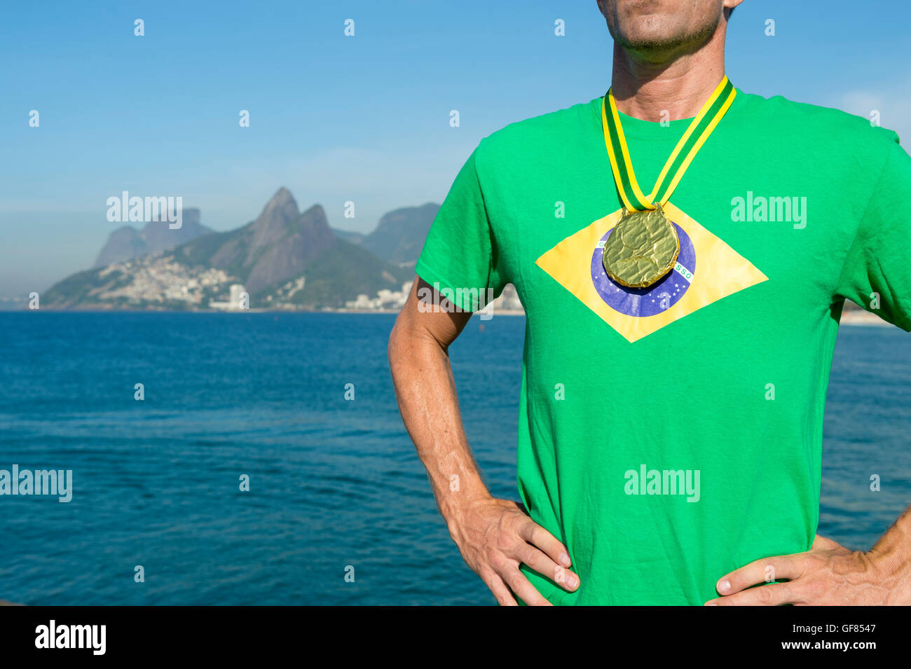 Man wearing gold medal on Brazil flag shirt standing in front of ...
