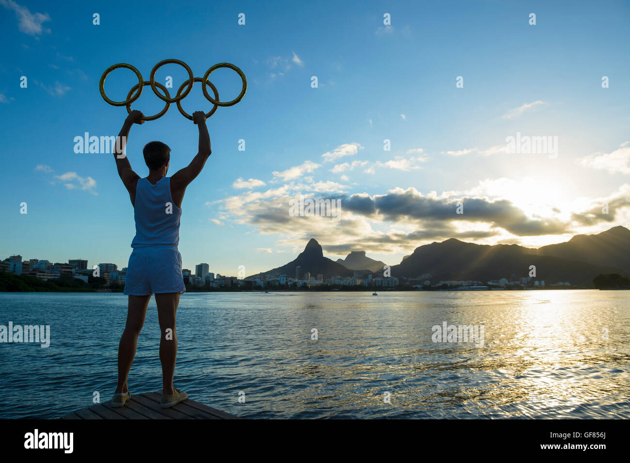 RIO DE JANEIRO - MARCH 05, 2015: Athlete holds Olympic rings above ...