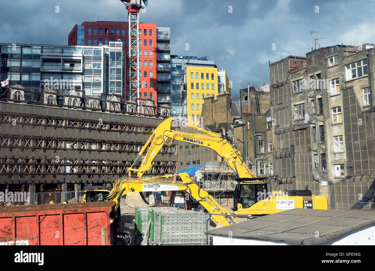 Digger on construction site with derelict buildings near Tottenham ...