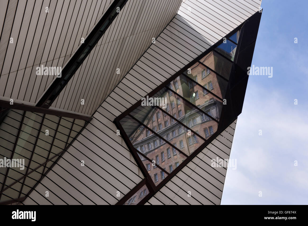 Old brick highrise reflected in the modern Royal Ontario Museum crystal ...