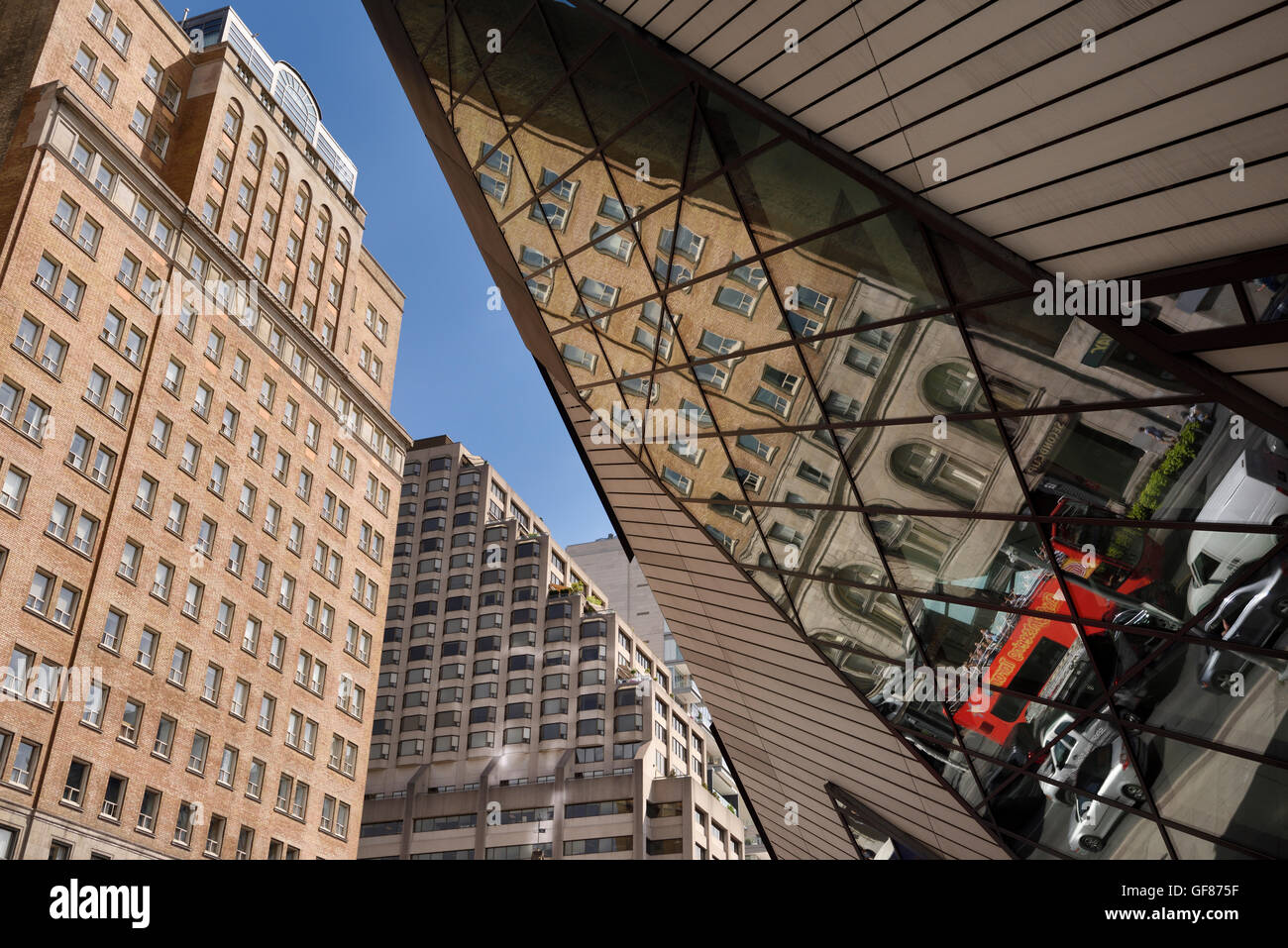Toronto sightseeing tour bus on Bloor street reflected in glass of the ...