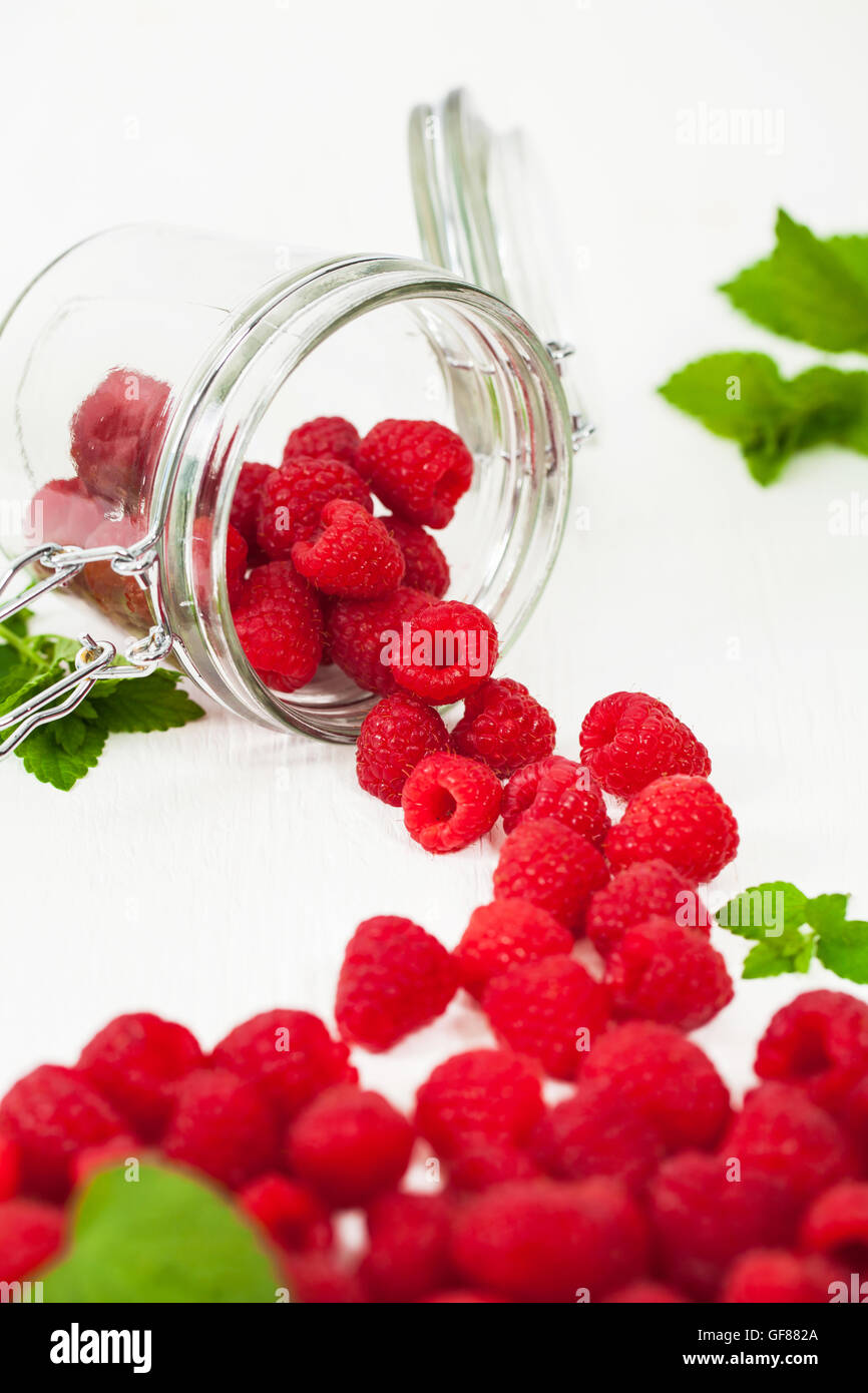 Ripe raspberry with green leaf background Stock Photo - Alamy