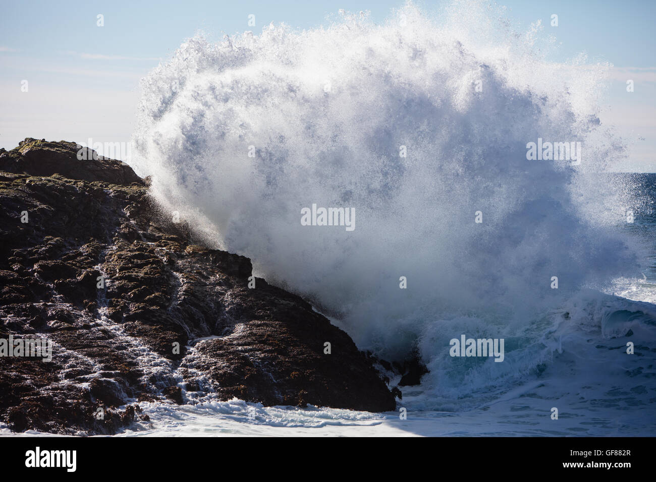 A powerful wave from the Pacific Ocean crashes against the dramatic ...
