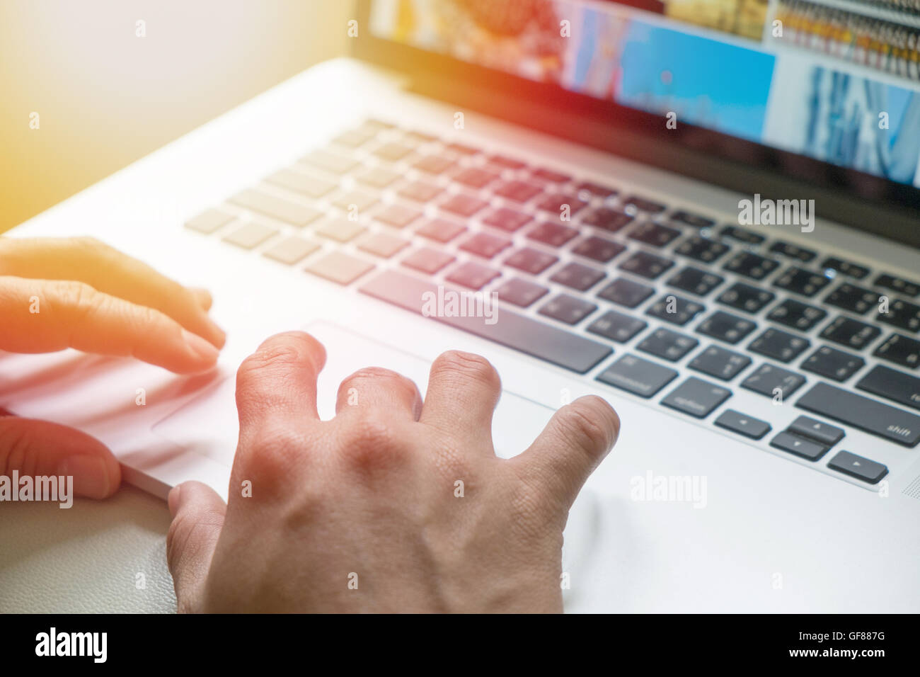 hands with laptop typing in sunlight Stock Photo - Alamy