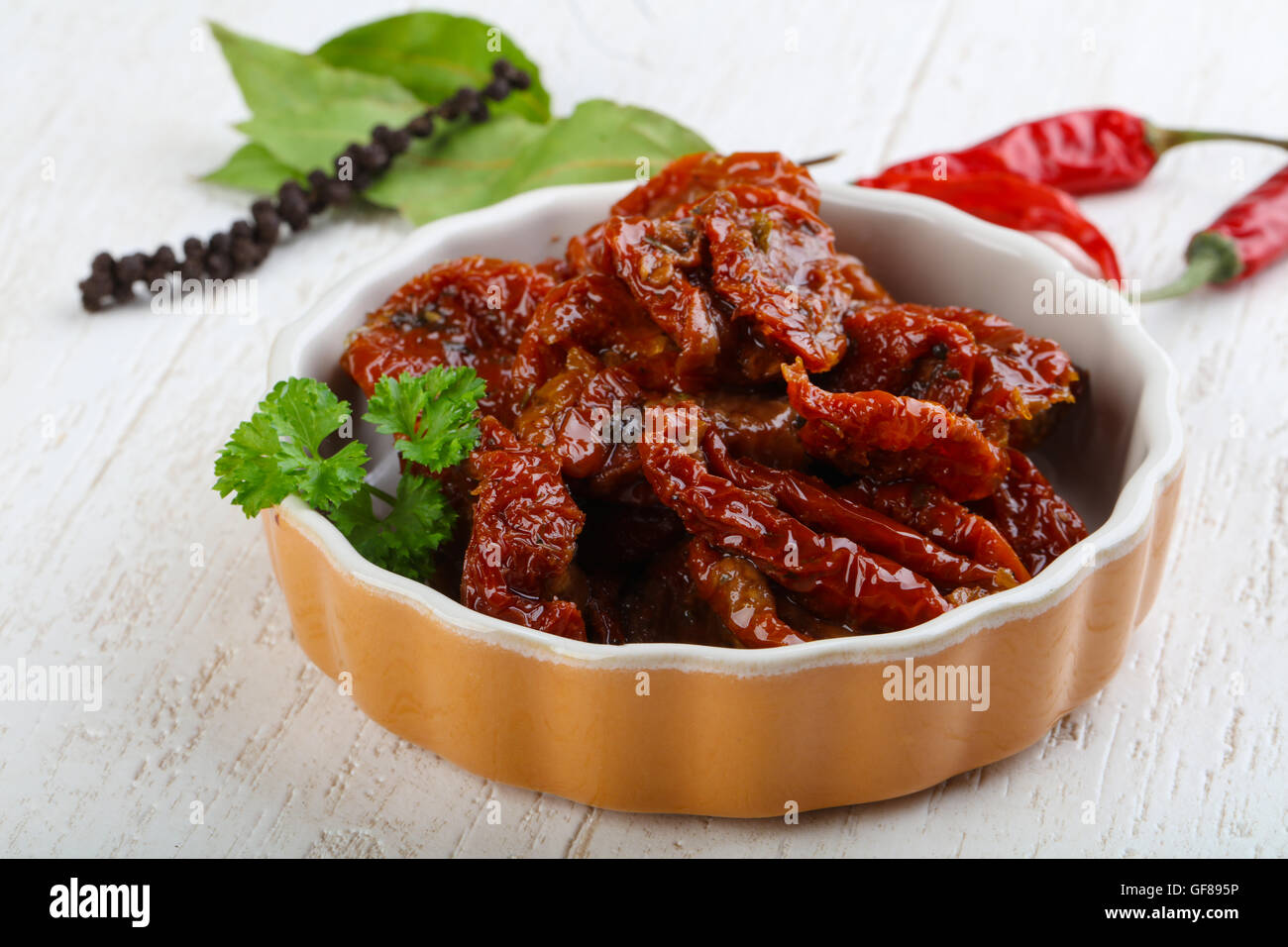 Dry tomato in olive oil with pepper Stock Photo - Alamy
